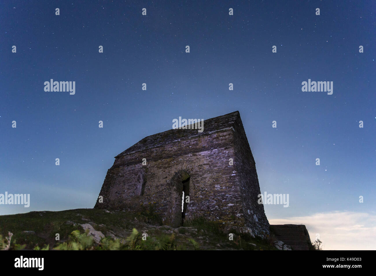 The chapel of St Michael under a starry sky torchlit during exposure ...