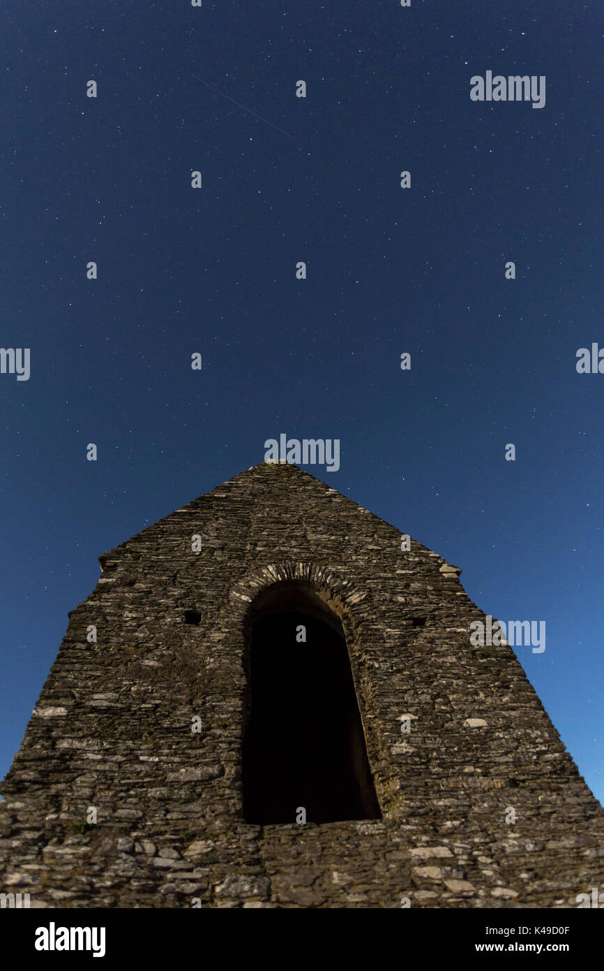 The chapel of St Michael under a starry sky torchlit during exposure ...