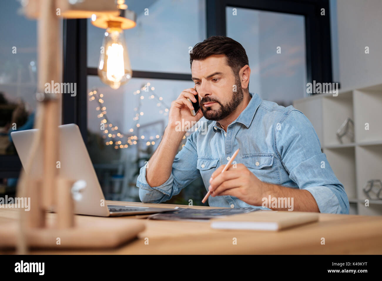 Serious handsome man making a call Stock Photo - Alamy