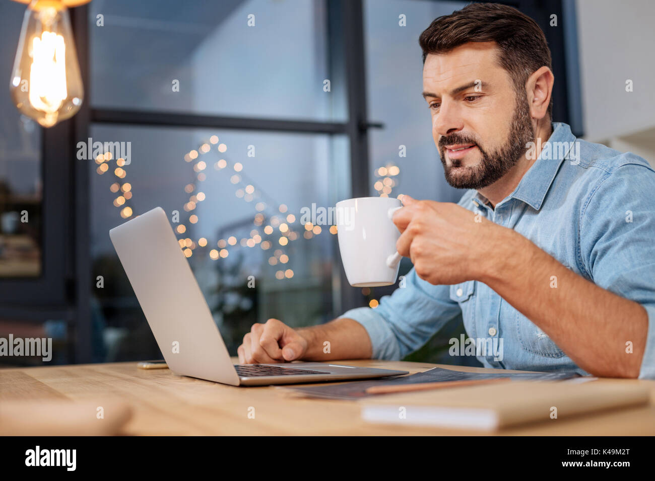 Pleasant hard working man enjoying his drink Stock Photo - Alamy