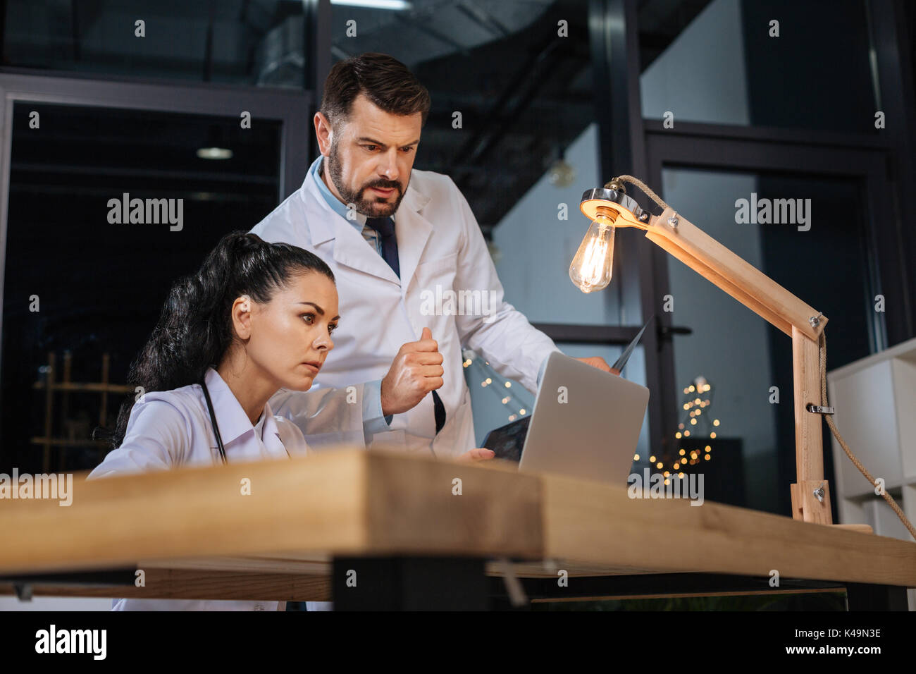 Smart modern researchers looking at the laptop screen Stock Photo - Alamy