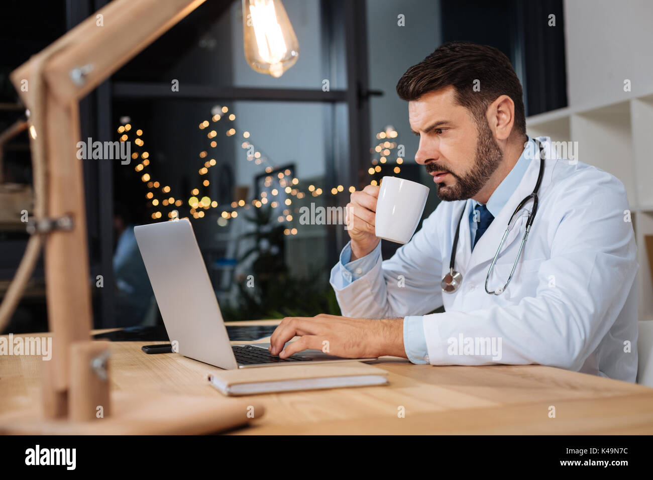 Serious hard working doctor having a night shift Stock Photo - Alamy