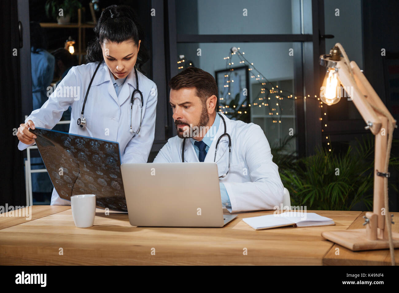 Smart experienced man studying an X ray photo Stock Photo - Alamy