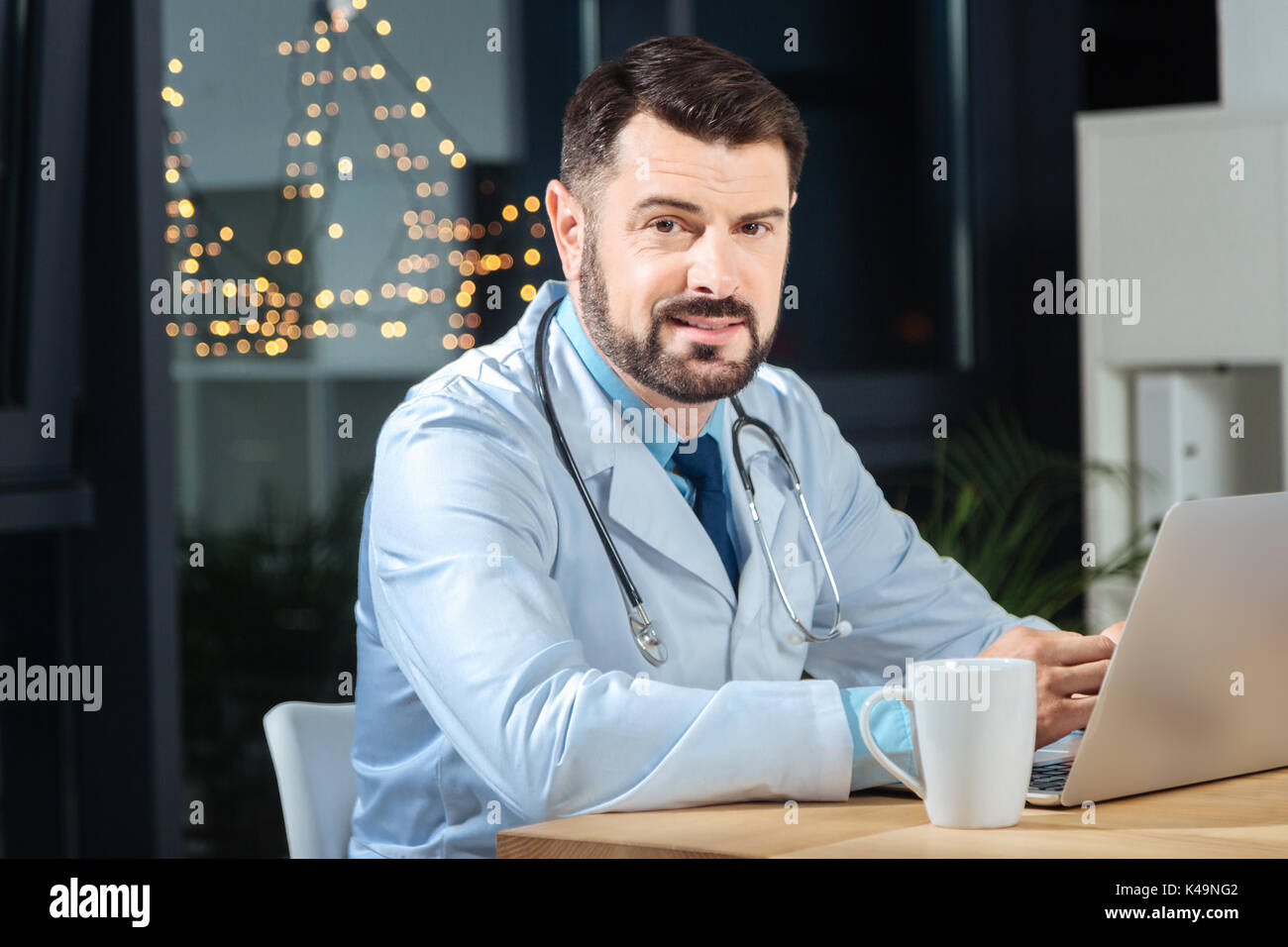 Smart nice doctor looking at you Stock Photo - Alamy