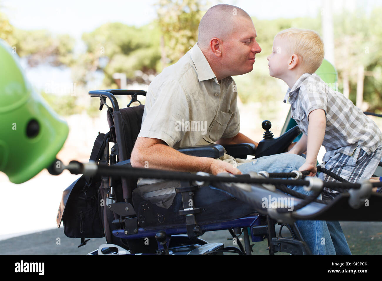 Disabled father play with little son on the playground Stock Photo - Alamy