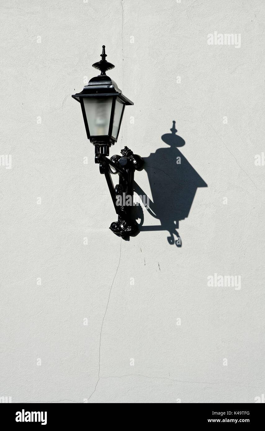 Black Lantern With Black Shadows On The White Wall Stock Photo - Alamy