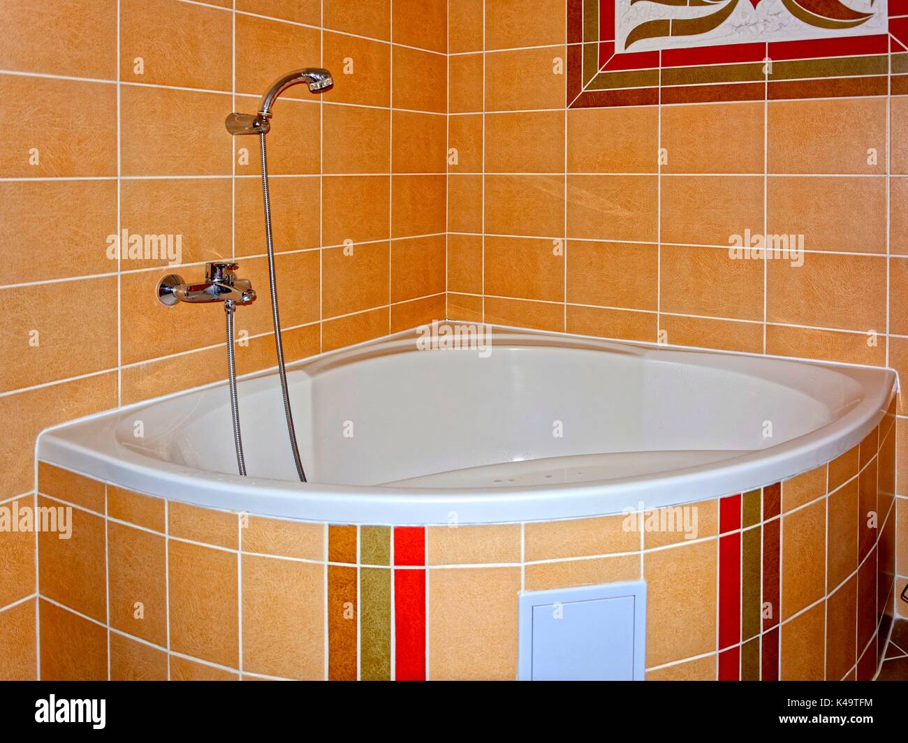 Corner Bathtub With Brown Tiles Stock Photo - Alamy