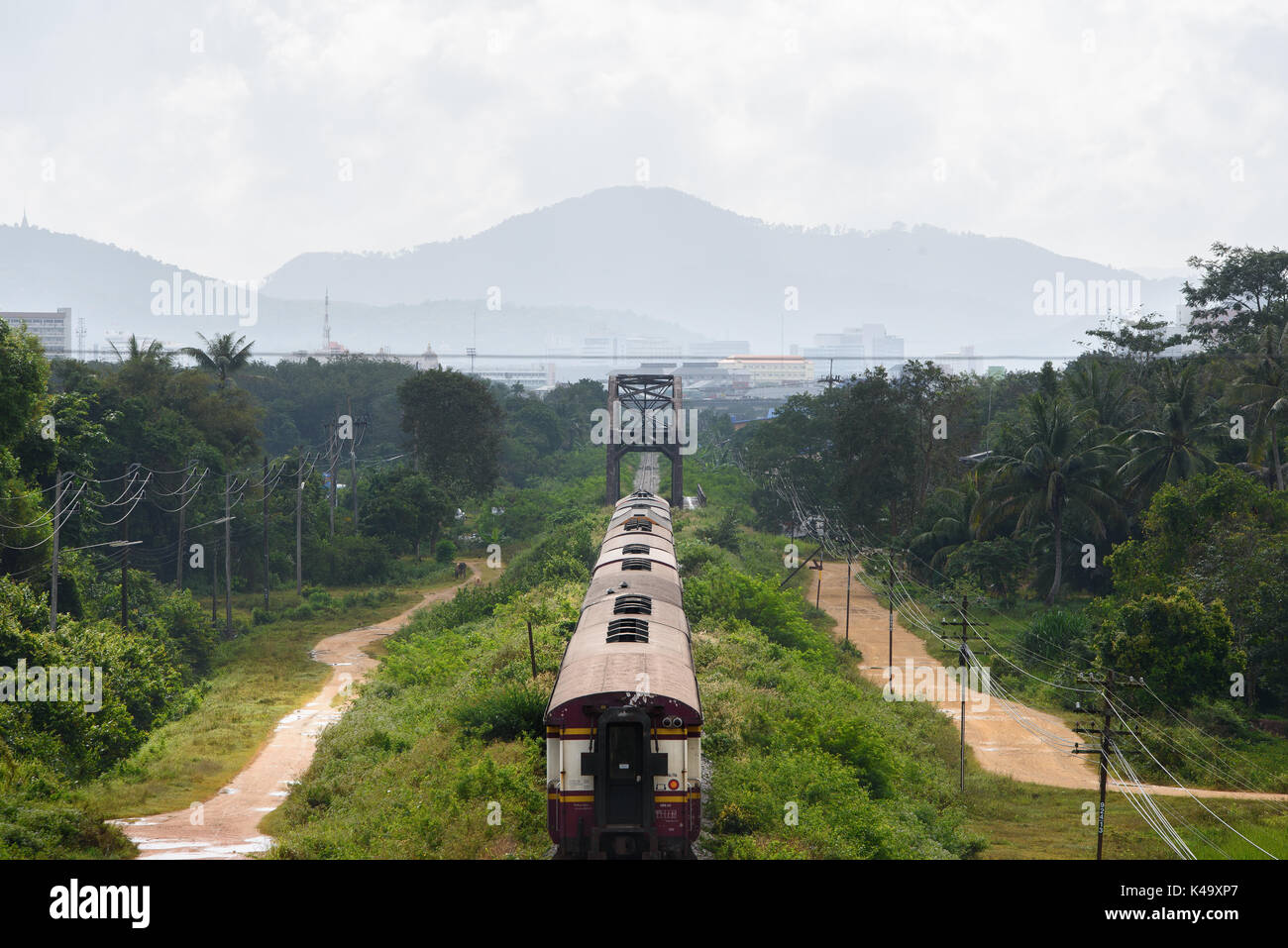 The classic train run in straight line from forest countryside to city ...