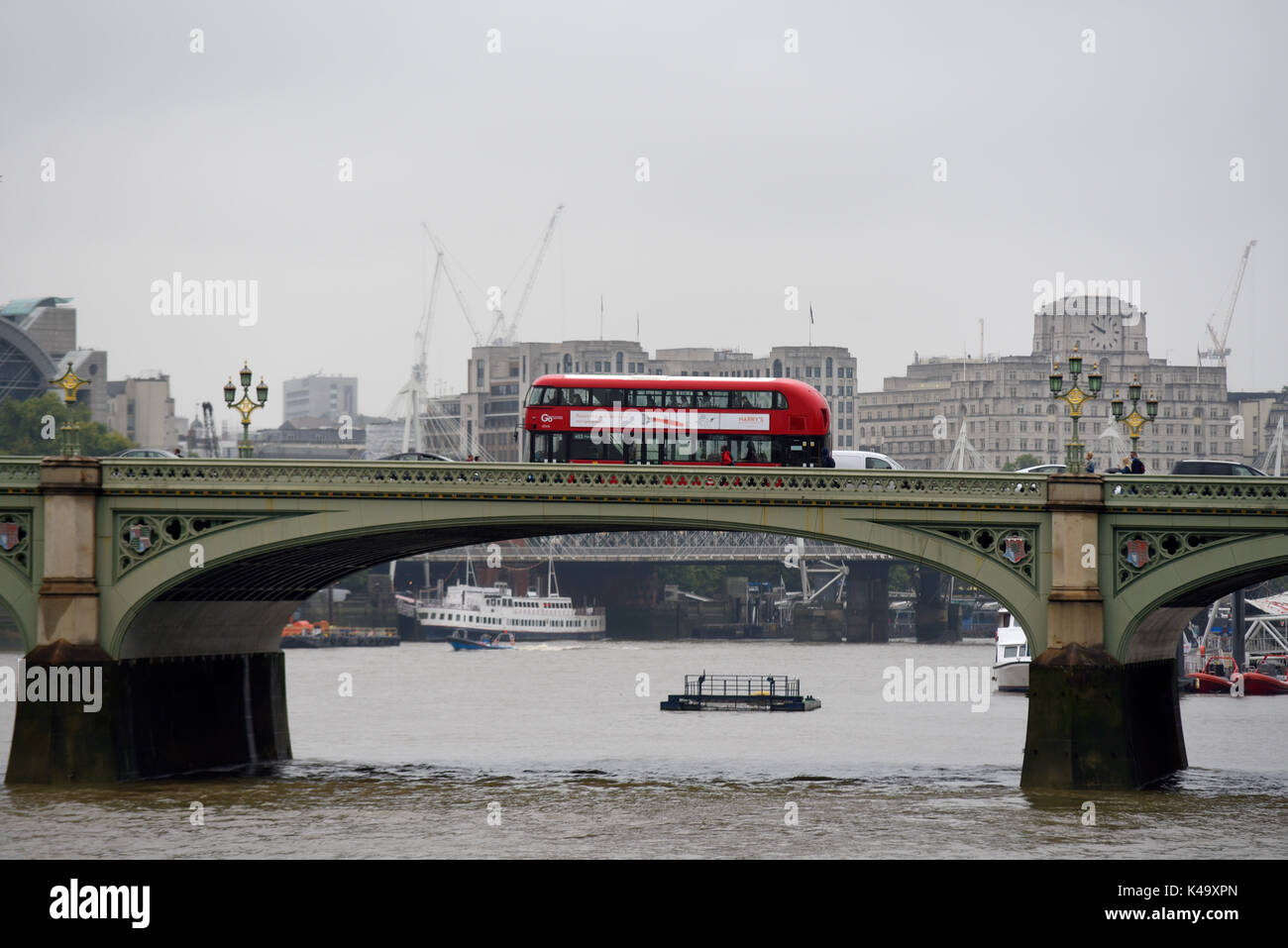 A red London bus crossing Westminster Bridge, London, England, UK in ...