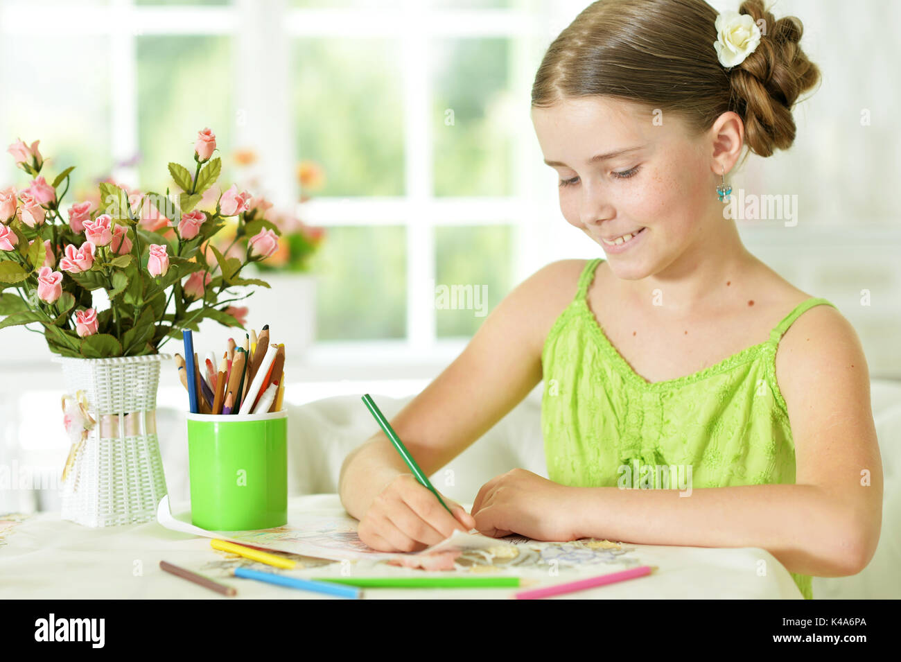 Cute girl drawing with pencils Stock Photo - Alamy