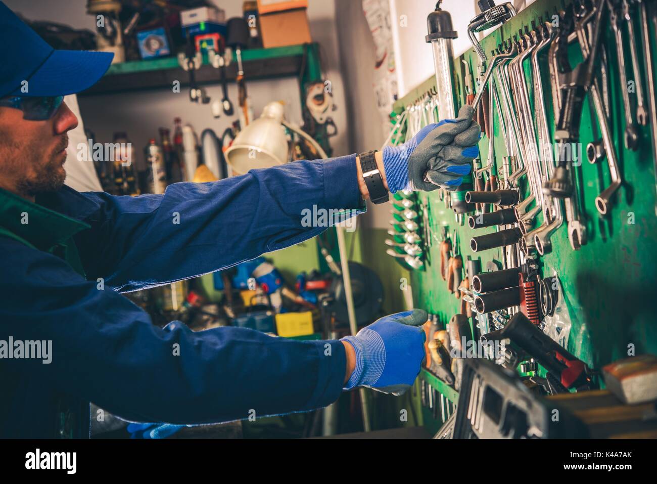 Car Mechanic and His Shop Tools. Caucasian Mechanic Choosing Right Tool ...