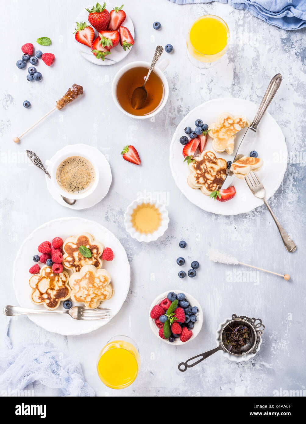 Flat lay with breakfast with scotch pancakes in flower form, berries ...
