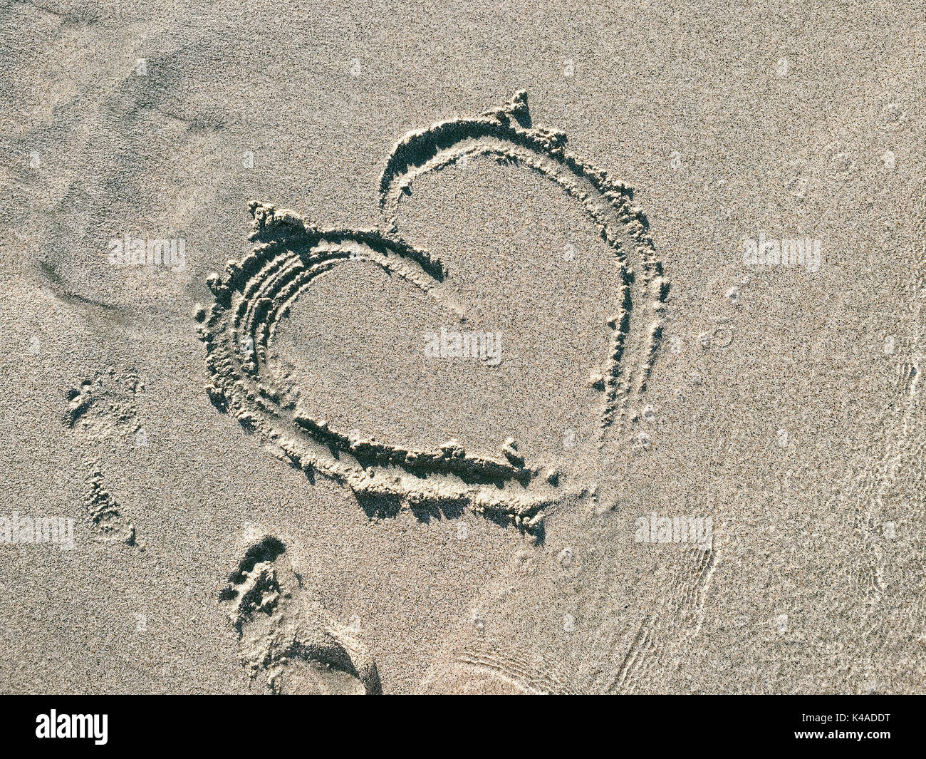 Heart Imprint On Ocean Beach Sand Stock Photo - Alamy