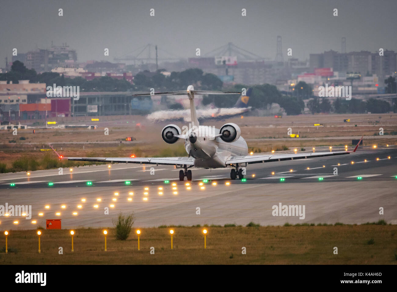 Modern small jet landing in the airport Stock Photo - Alamy