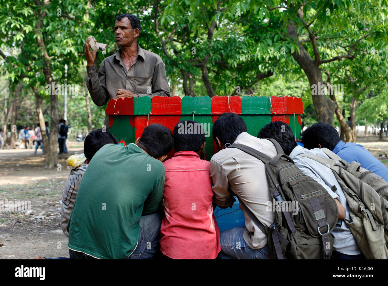 City dwellers watching still Movies or traditional bioscope during the ...