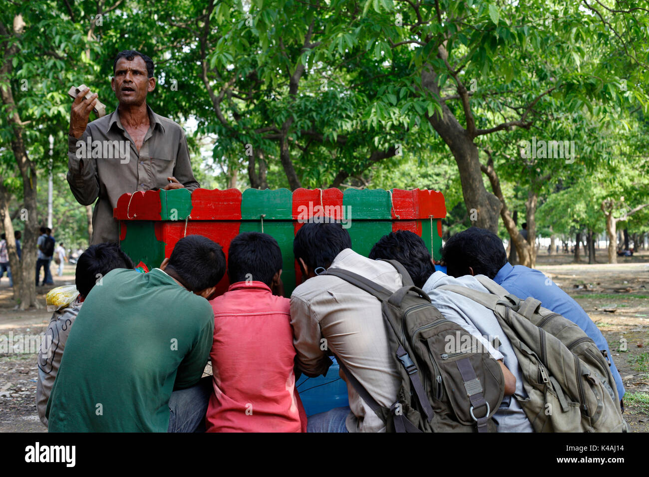 City dwellers watching still Movies or traditional bioscope during the ...