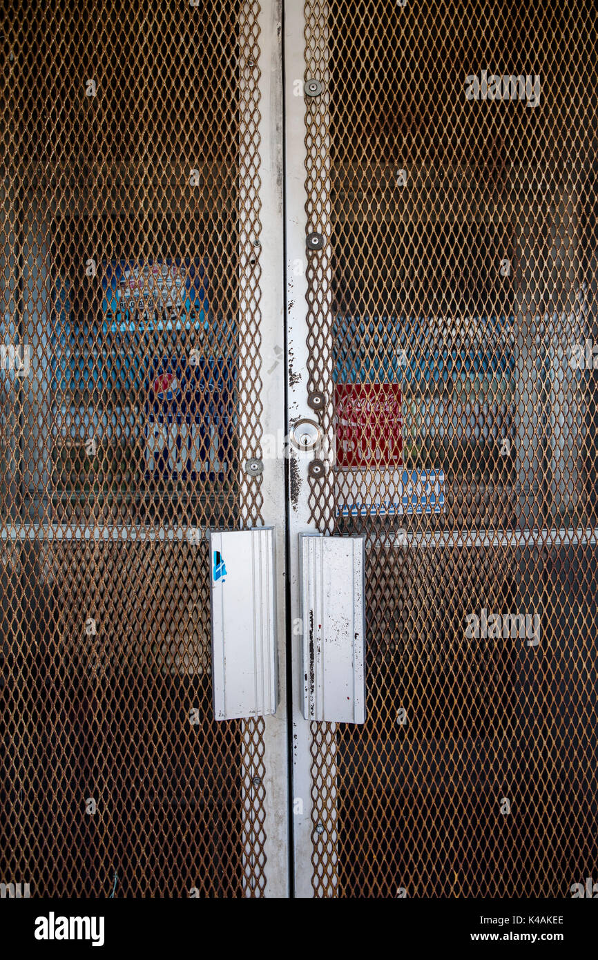 Old closed run down shop and locked door with wire front in Utah, USA ...