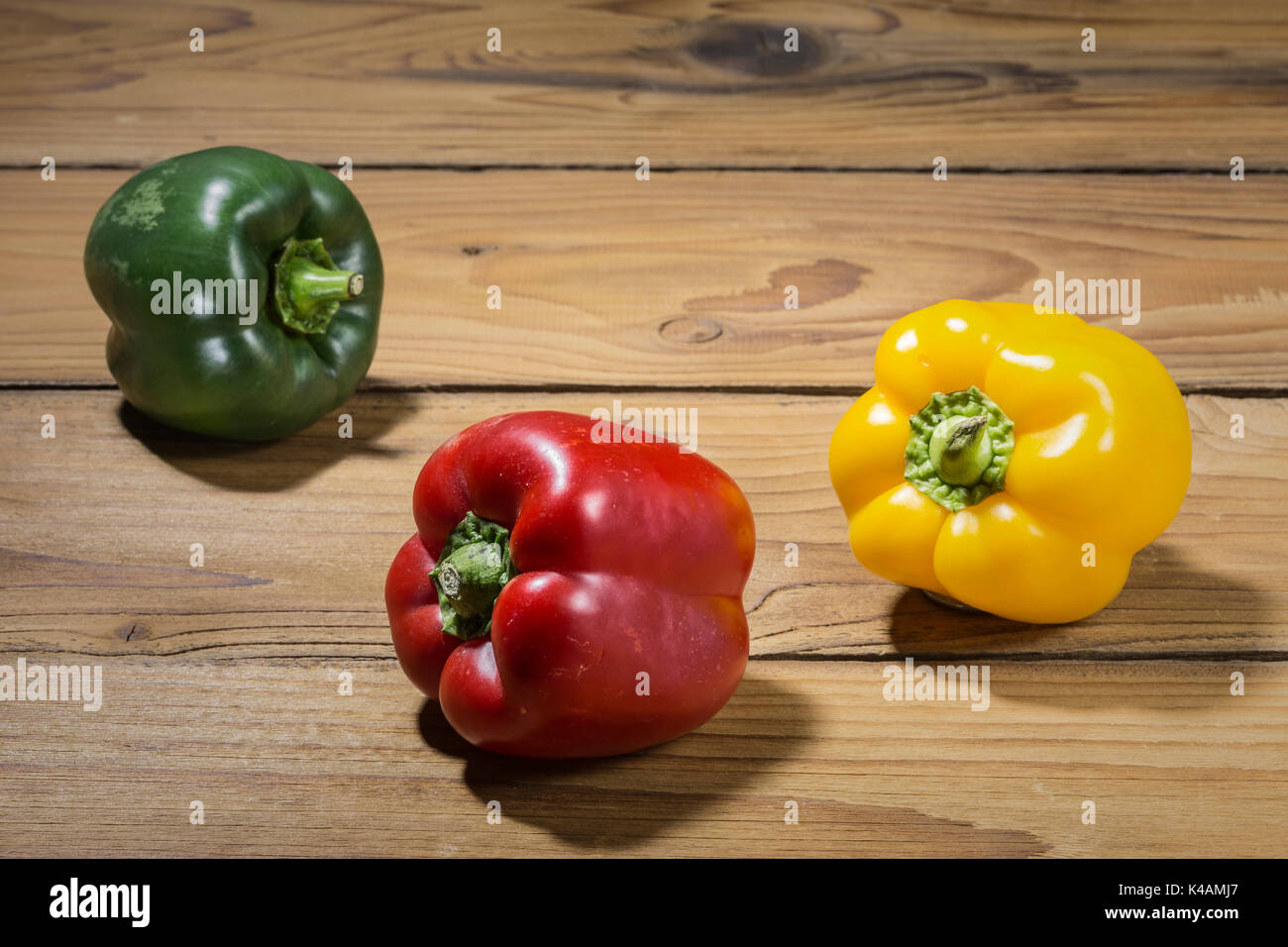 Paprika Trio Lying On Wooden Underground Stock Photo - Alamy