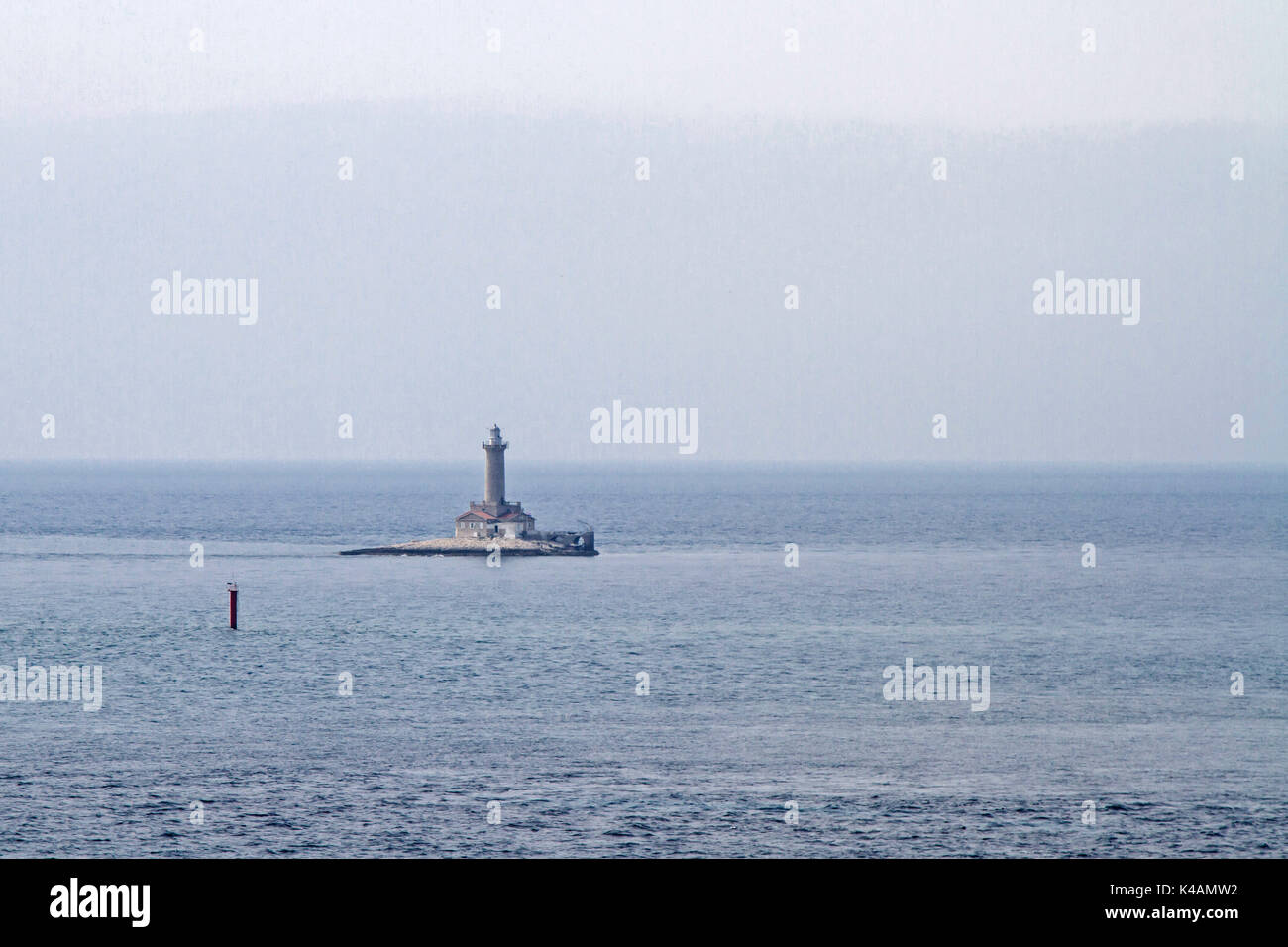 Lighthouse Porer On A Small Rocky Island In Front Of The Isolated ...