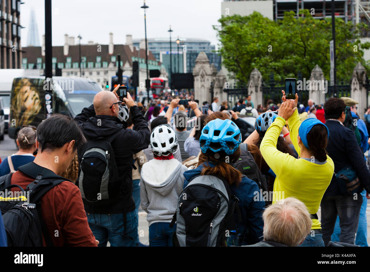 London, UK. A crowd takes photographs of Big Ben from Parliament Square ...