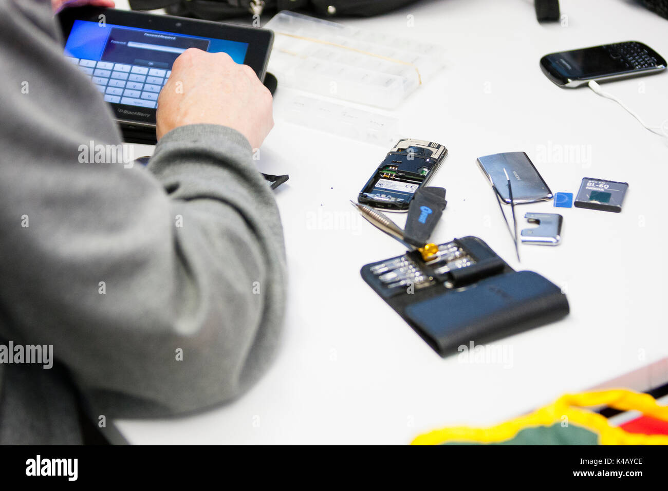 London, UK. Components of a mobile phone are seen on a table Stock ...