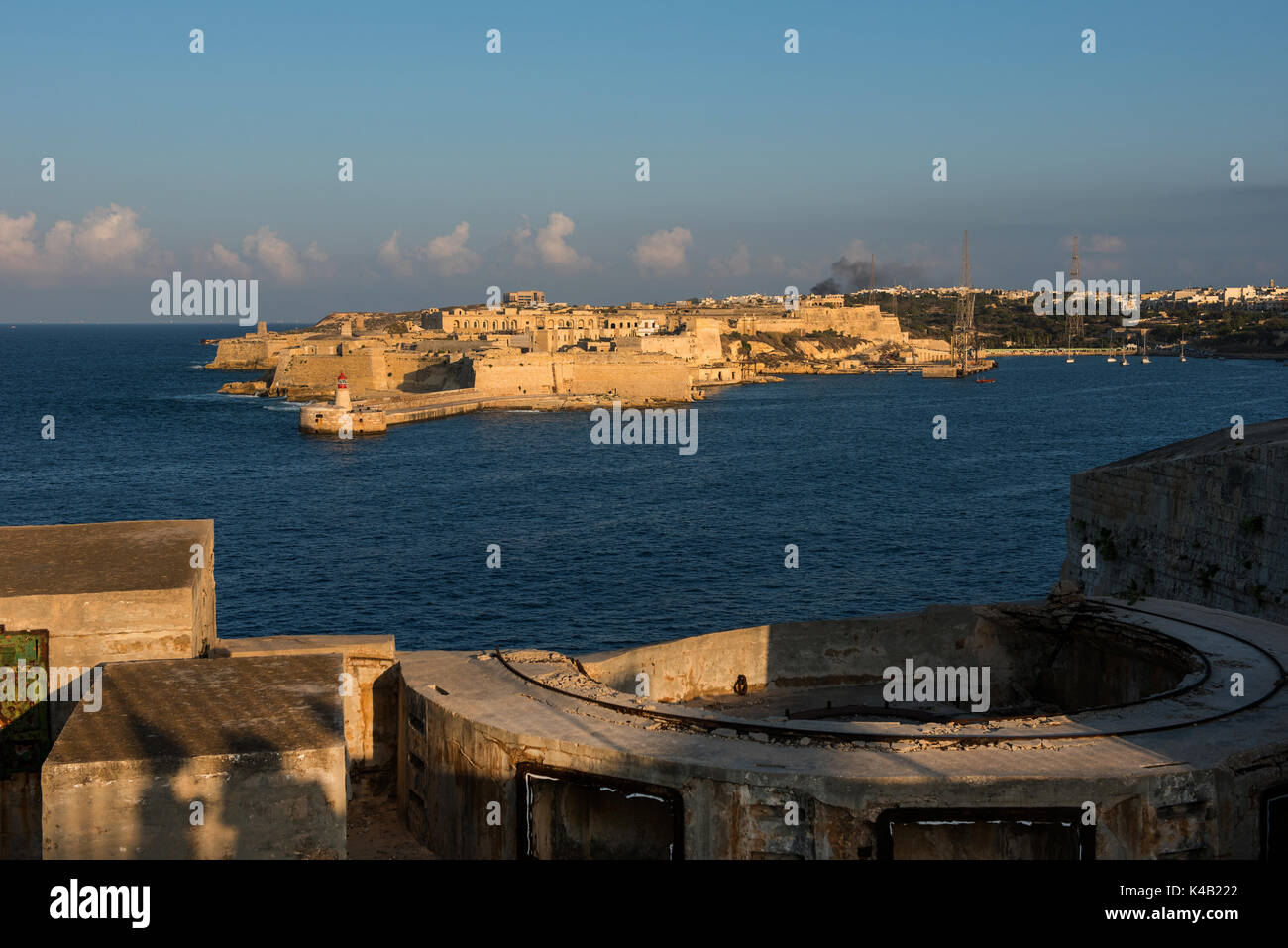 Ancient walls and buildings of Valetta fortress in late afternoon ...