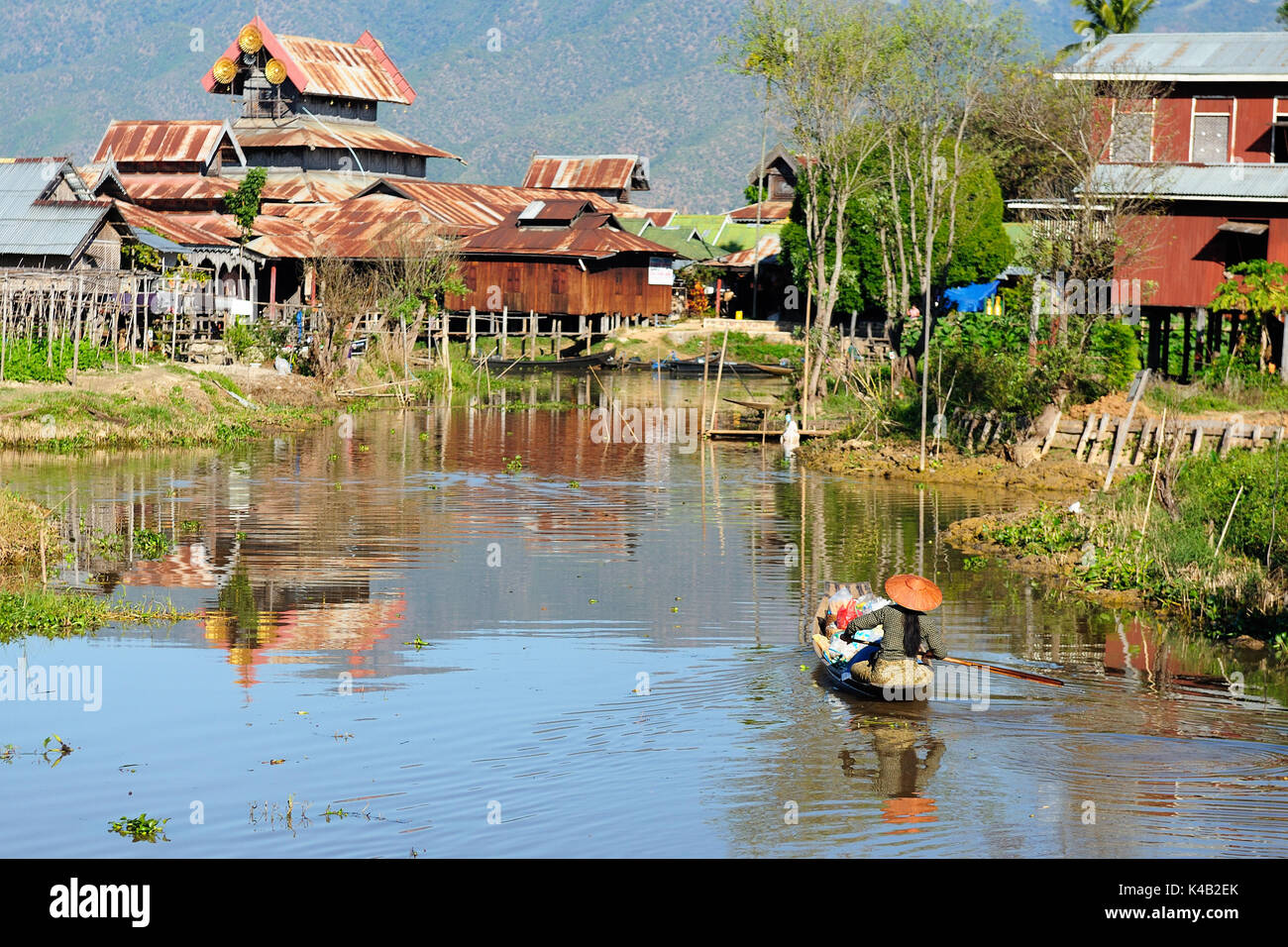 Ancient houses and their reflection and boat sailing between them in ...