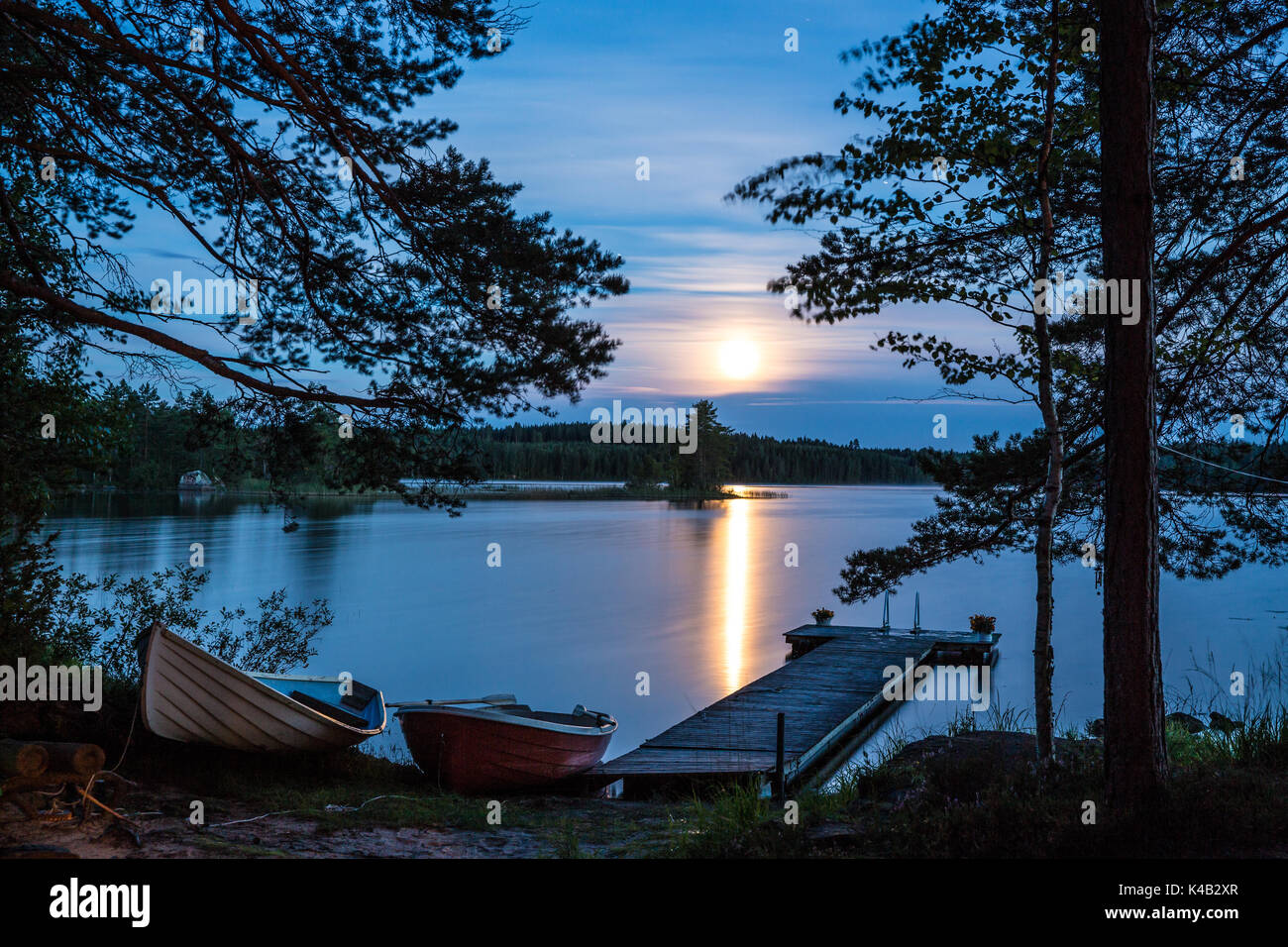 Two Rowing Boats In Moonlight Stock Photo - Alamy