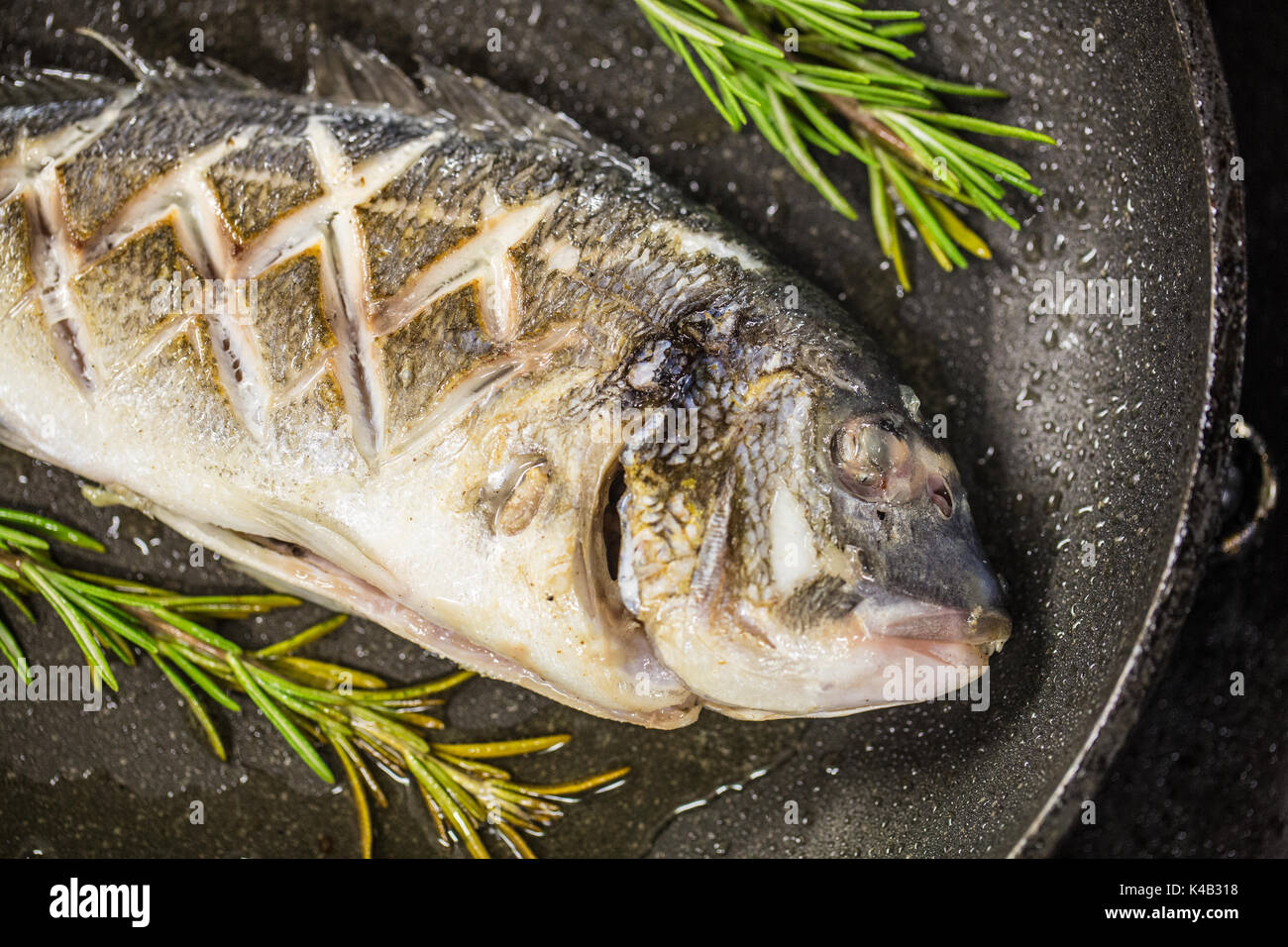 Fried Gilthead Fish In A Pan Stock Photo - Alamy
