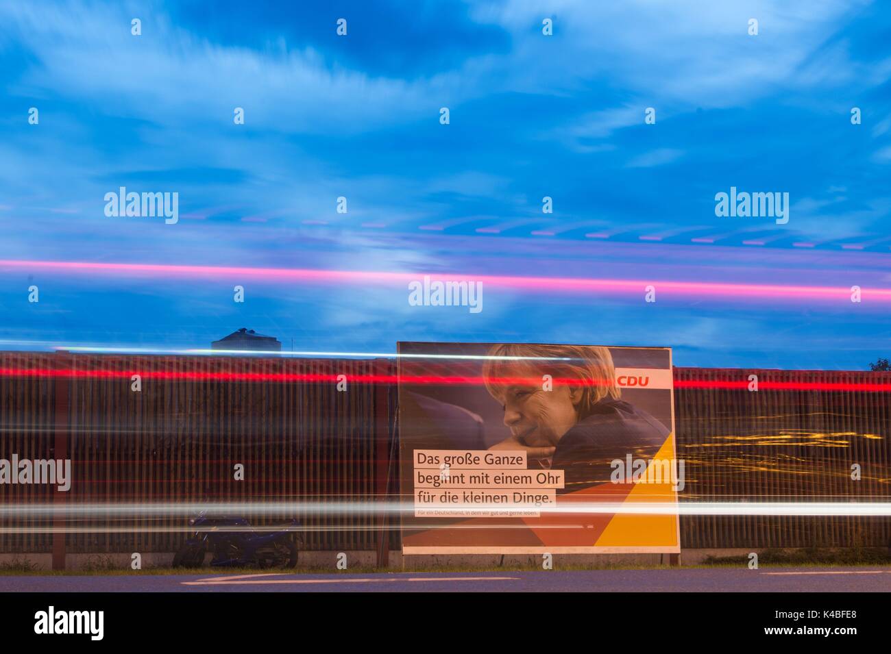 Dresden, Germany. 5th Sep, 2017. Cars drive past a campaign poster for ...