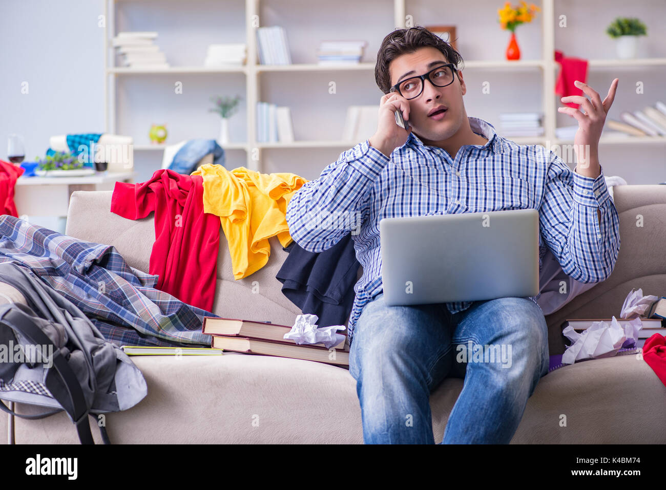 Young man working studying in messy room Stock Photo - Alamy