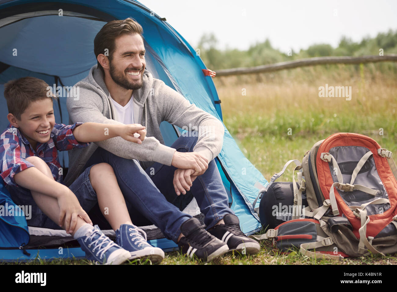 Father and son resting outside the tent Stock Photo - Alamy