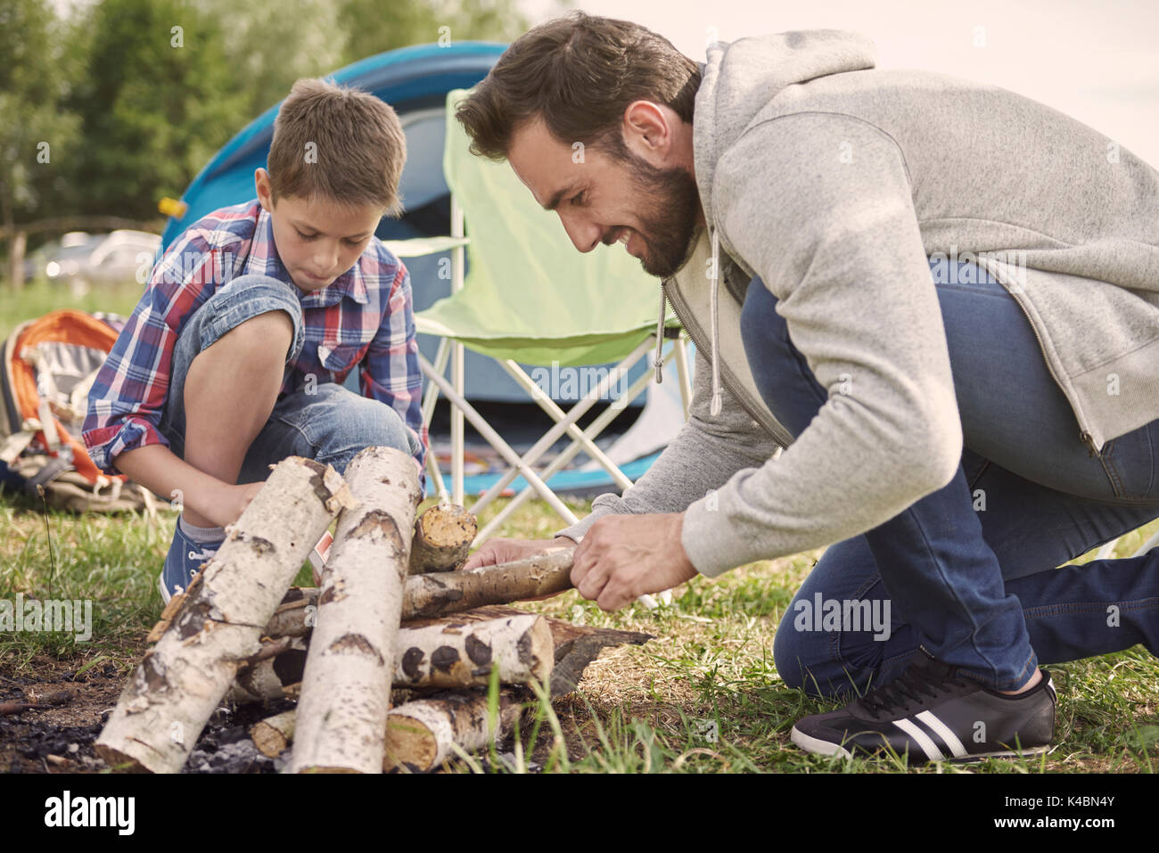 Pensive boy helping his father on camping Stock Photo - Alamy