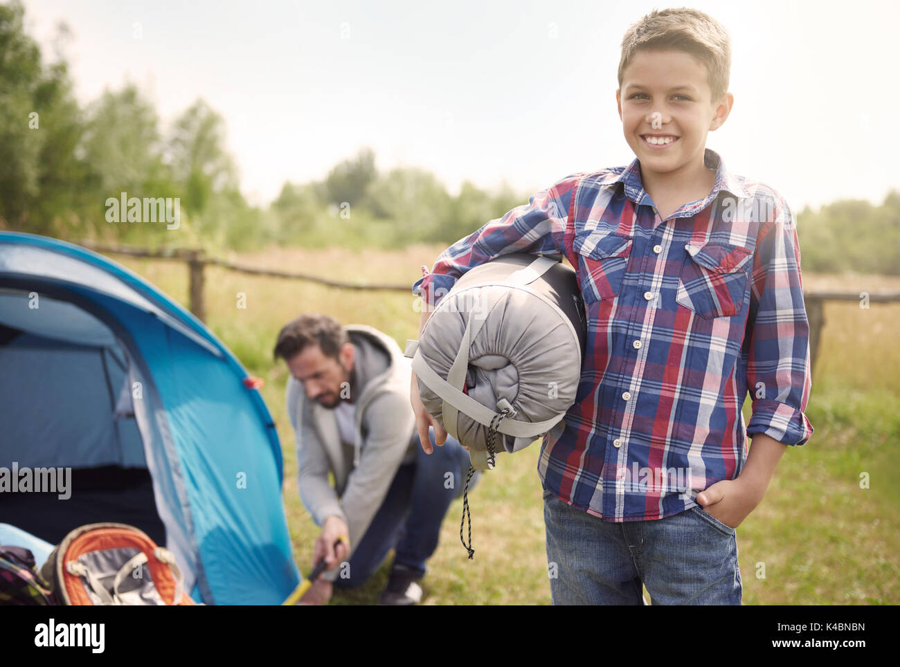 Son helping his father on camping Stock Photo - Alamy