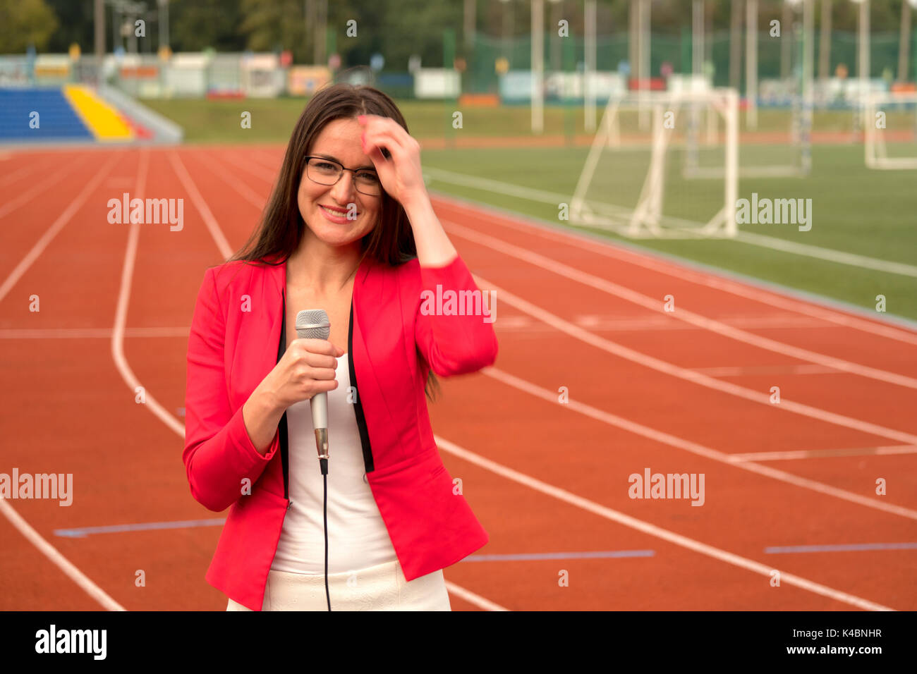 Pretty journalist is reporting from the stadium for television Stock ...