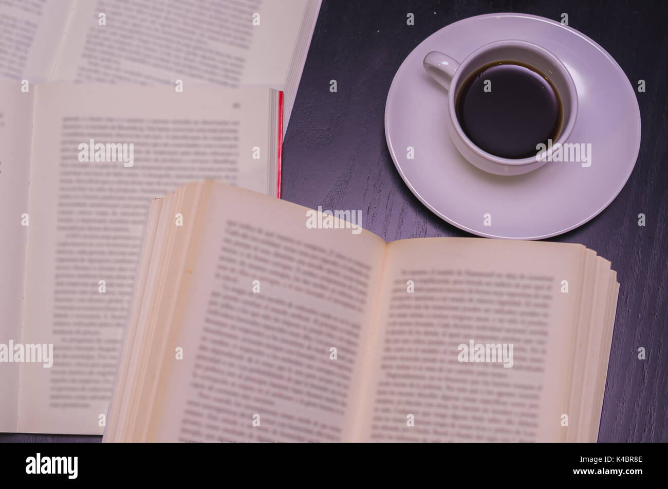 Reading a book and drinking coffee Stock Photo - Alamy