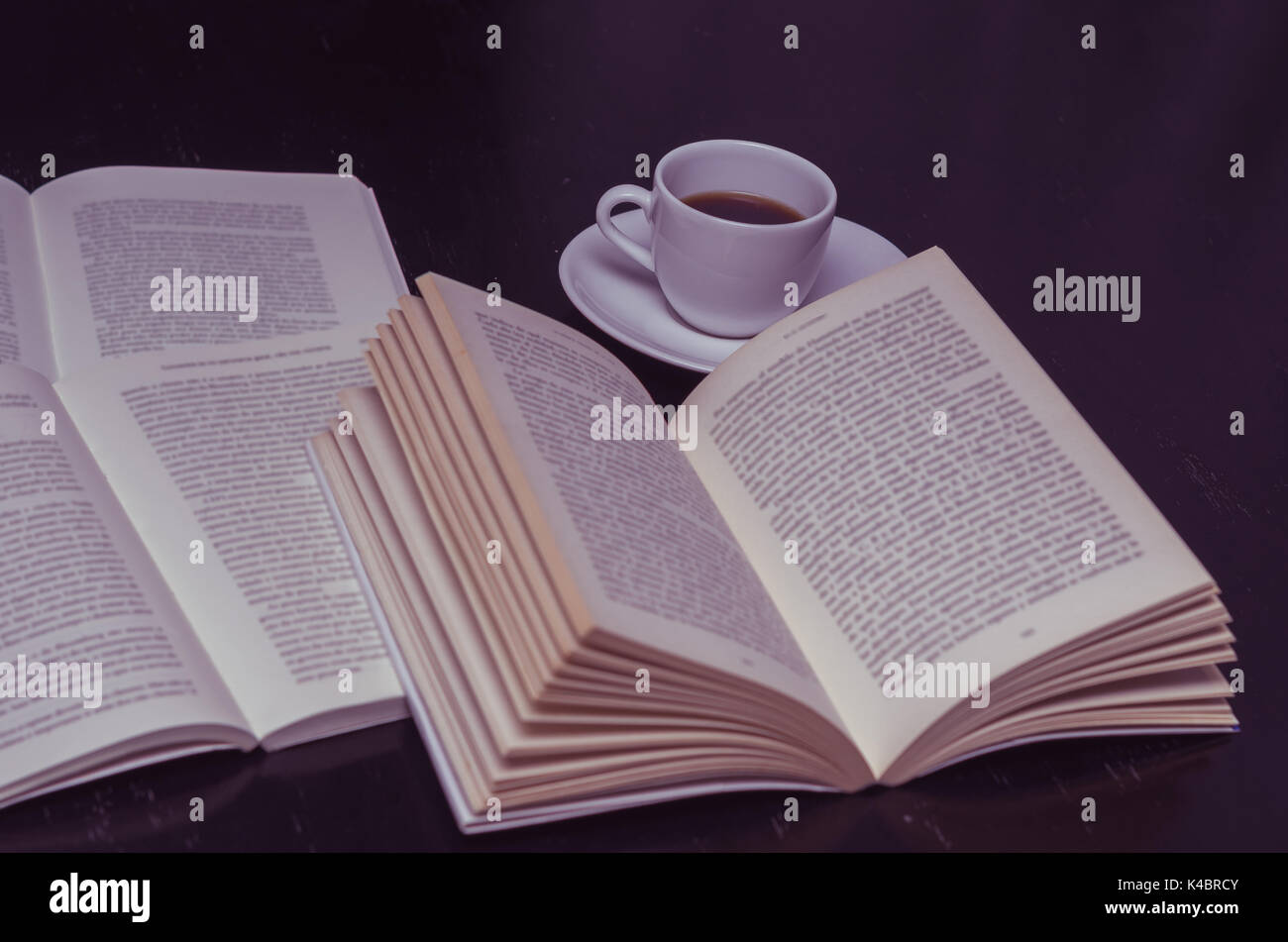 Reading a book and drinking coffee Stock Photo - Alamy