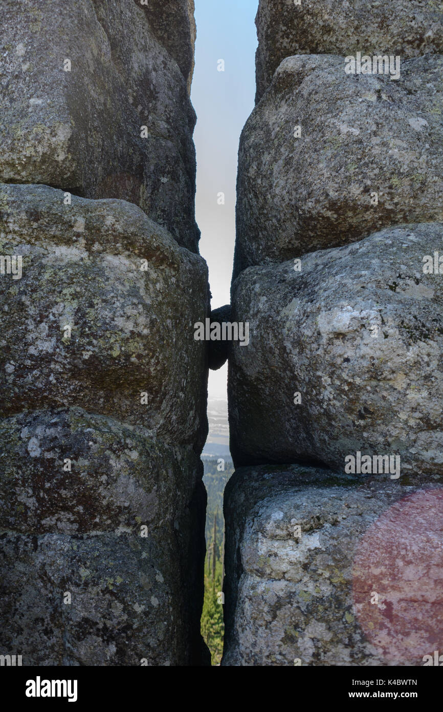 Small Stone Is Stuck Between Gaps Of Two Huge Boulders Stock Photo - Alamy