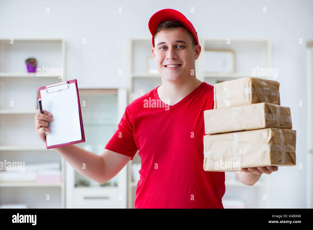 Post man delivering a parcel package Stock Photo - Alamy