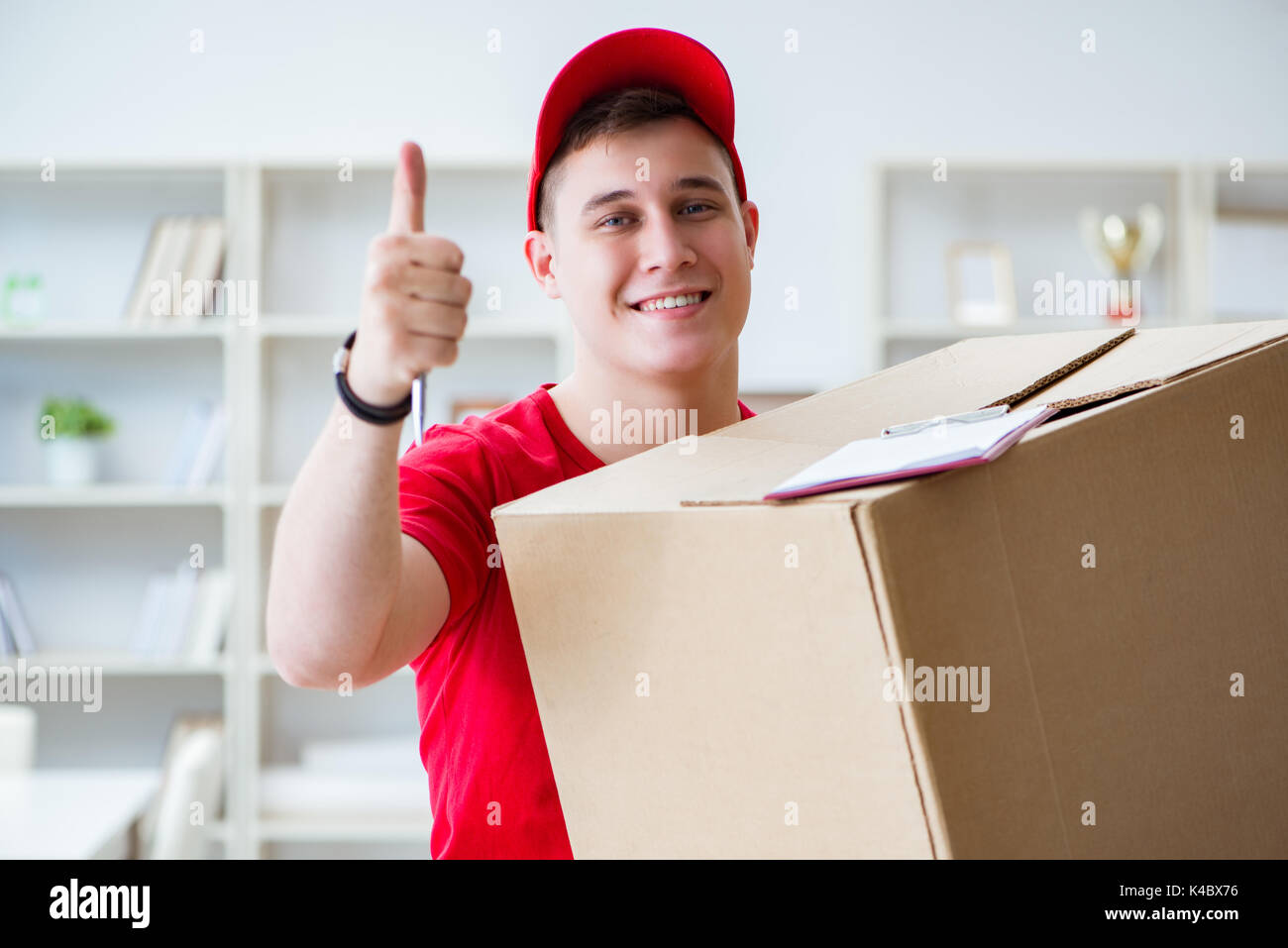 Post man delivering a parcel package Stock Photo - Alamy