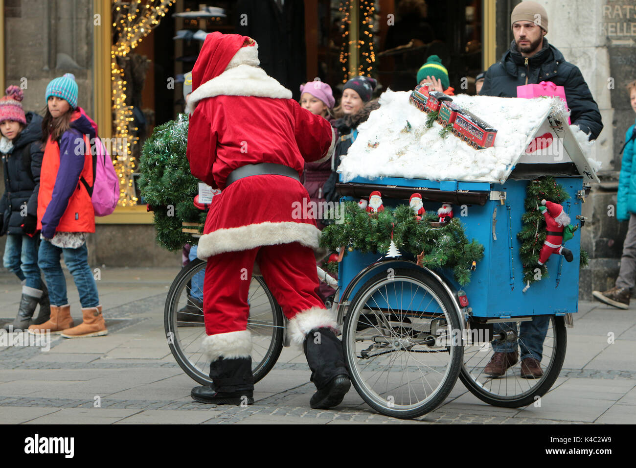 Santa Claus Pushing His Tricycle In Munich S Christmas Market Stock ...