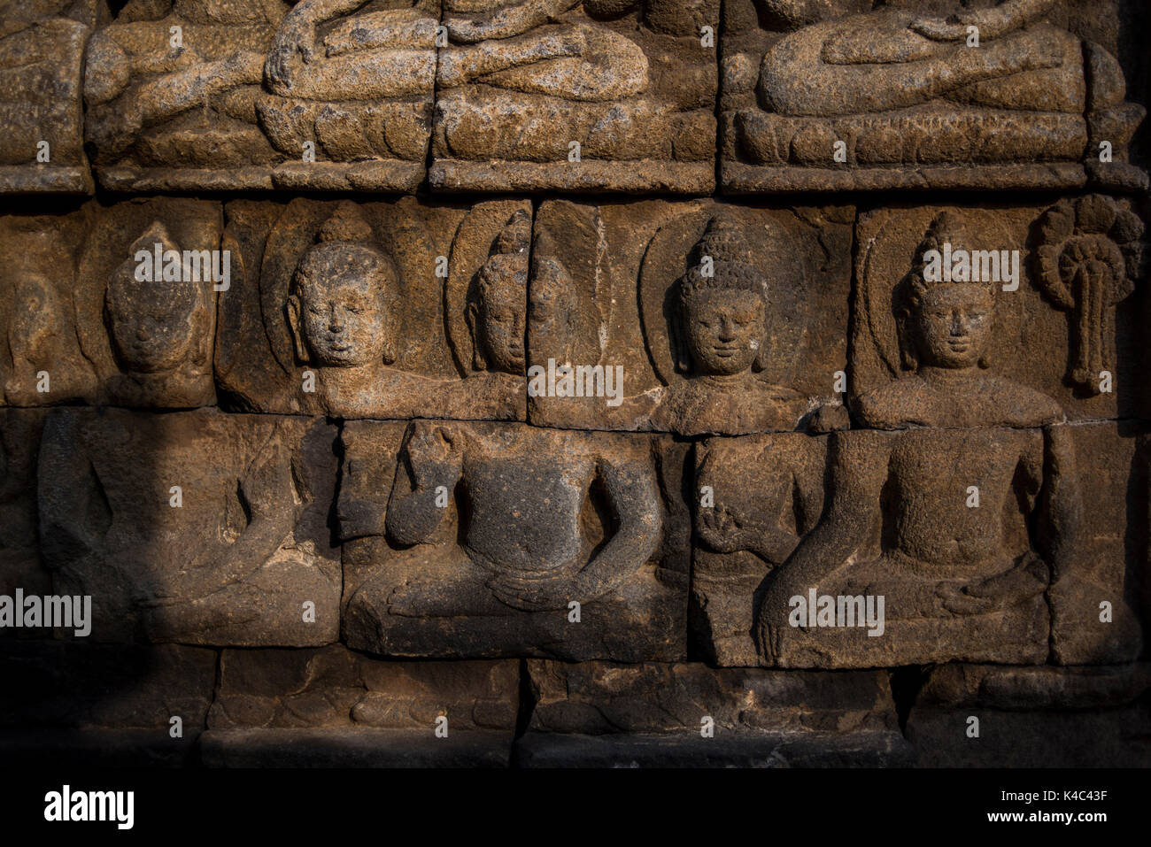 Buddhist stone carvings at the Borobudur temple in Java, Indonesia ...