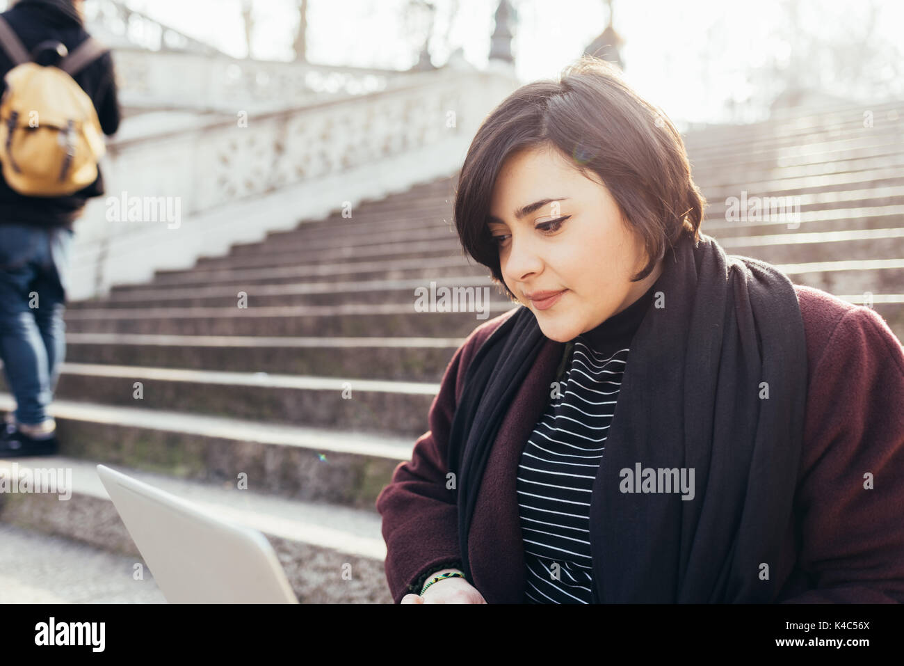 Young woman outdoor using computer - business woman, remote working ...
