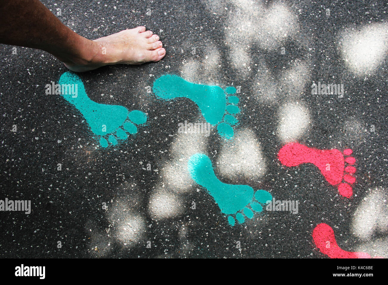 Colored Footprints On Walkway Stock Photo - Alamy
