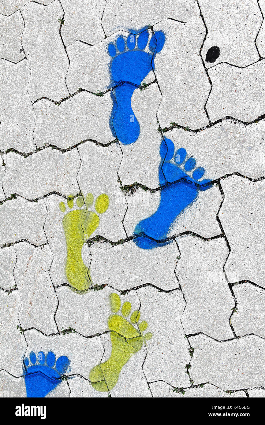 Colored Footprints On Walkway Stock Photo - Alamy