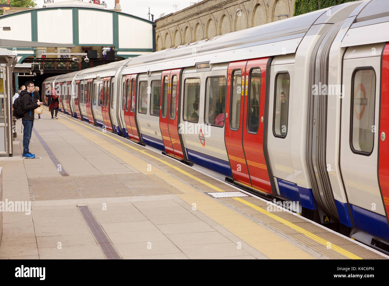 District Line train at West Brompton Underground station in London ...
