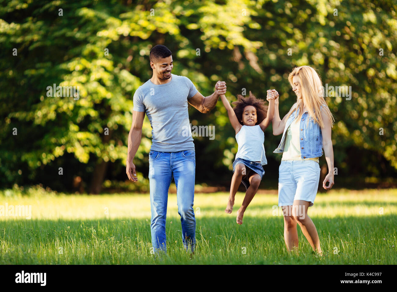 Happy young couple spending time with their daughter Stock Photo - Alamy