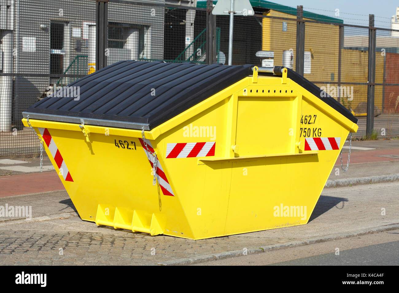 Yellow Rubble Container on the street Stock Photo - Alamy