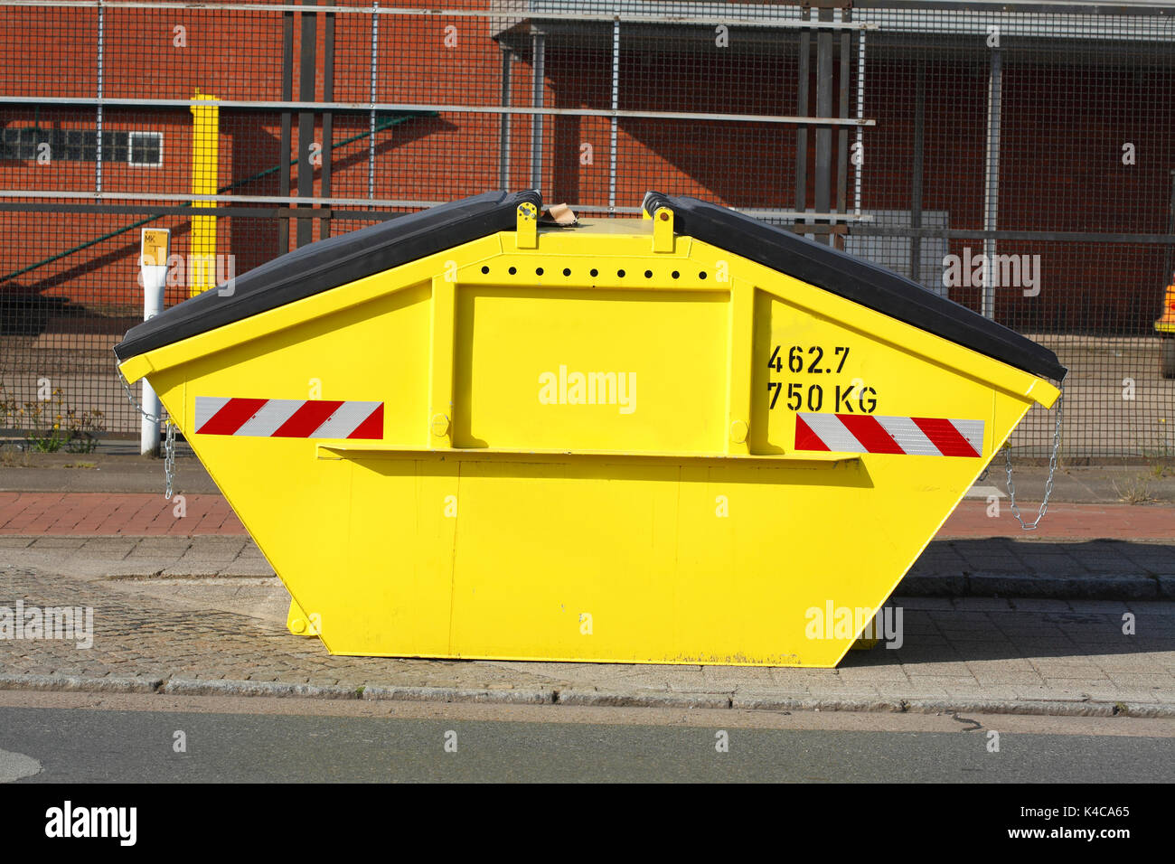 Yellow Rubble Container on the street Stock Photo - Alamy