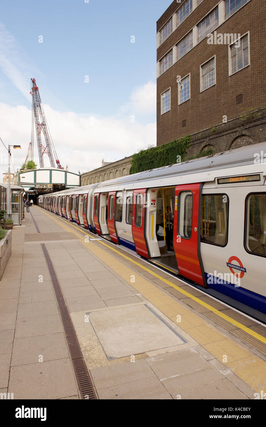 District Line train at West Brompton Underground station in London ...